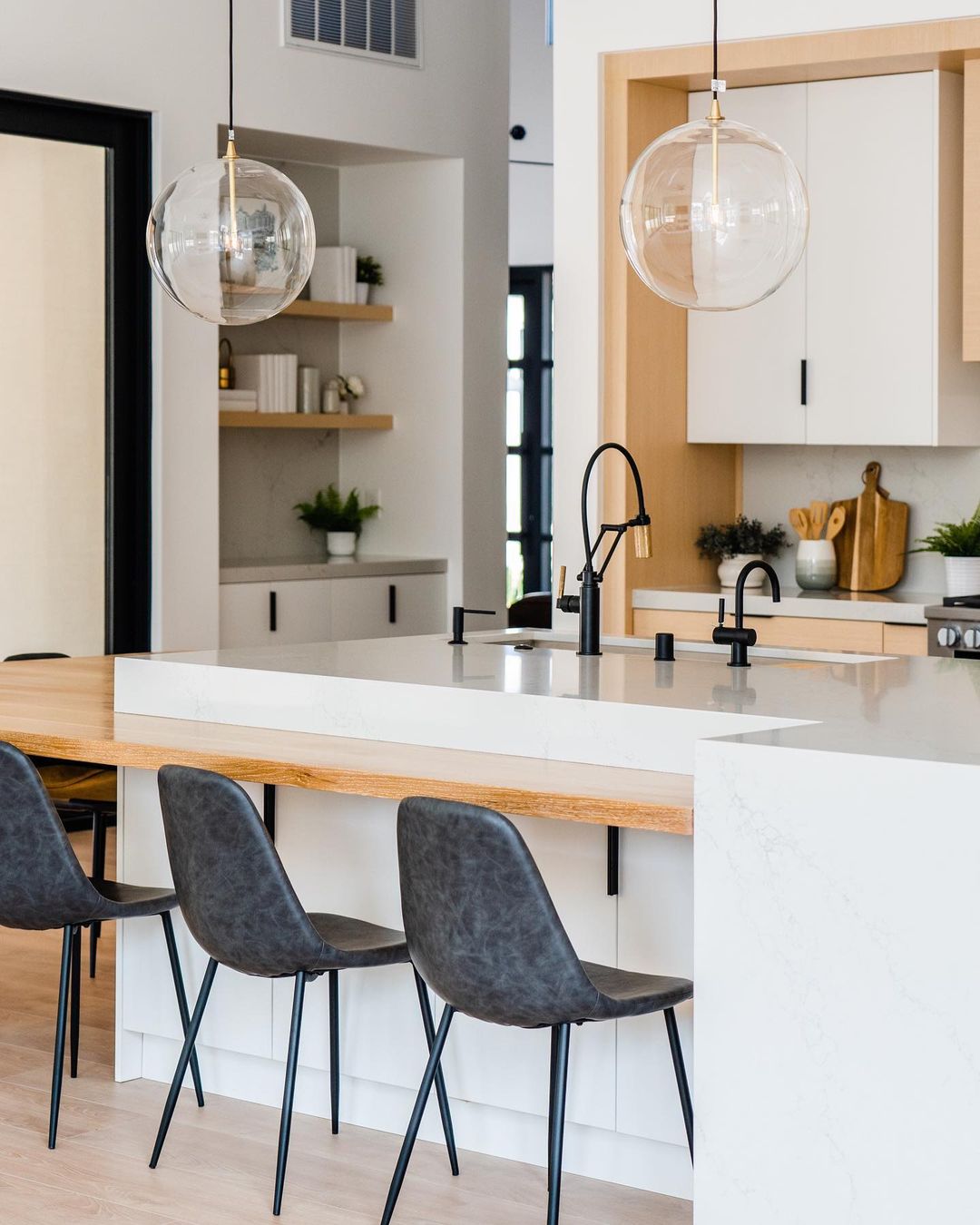 This statement-making waterfall island with a custom wood slab makes ...